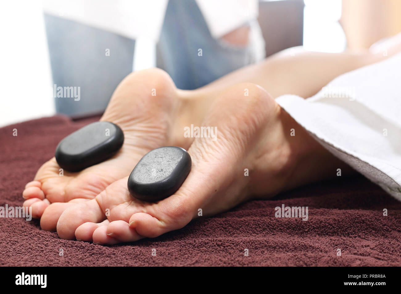 Acupressure. Massage with basalt stones.Massage with stones. Female ...