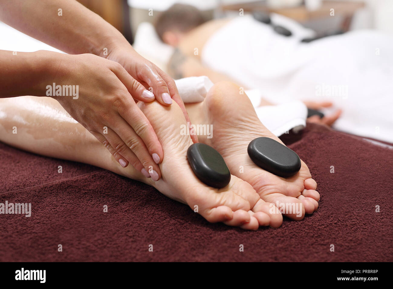 Acupressure. Massage with basalt stones.Massage with stones. Female ...