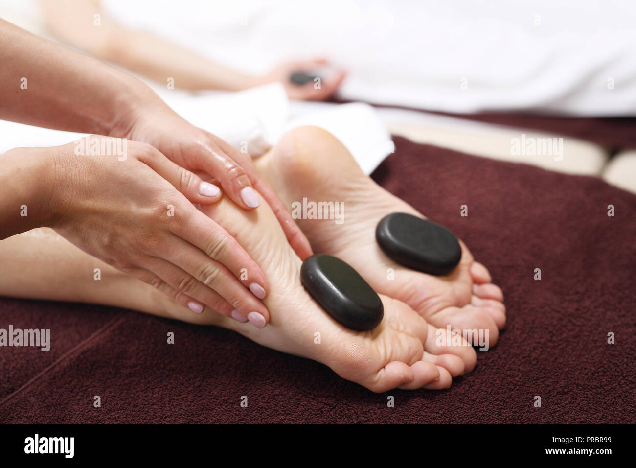 Acupressure. Massage with basalt stones.Massage with stones. Female ...