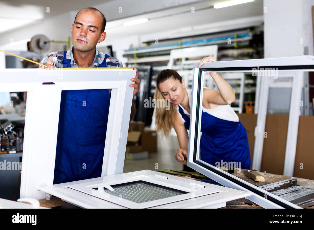 Glad brigade of two people working at workshop for production of ...