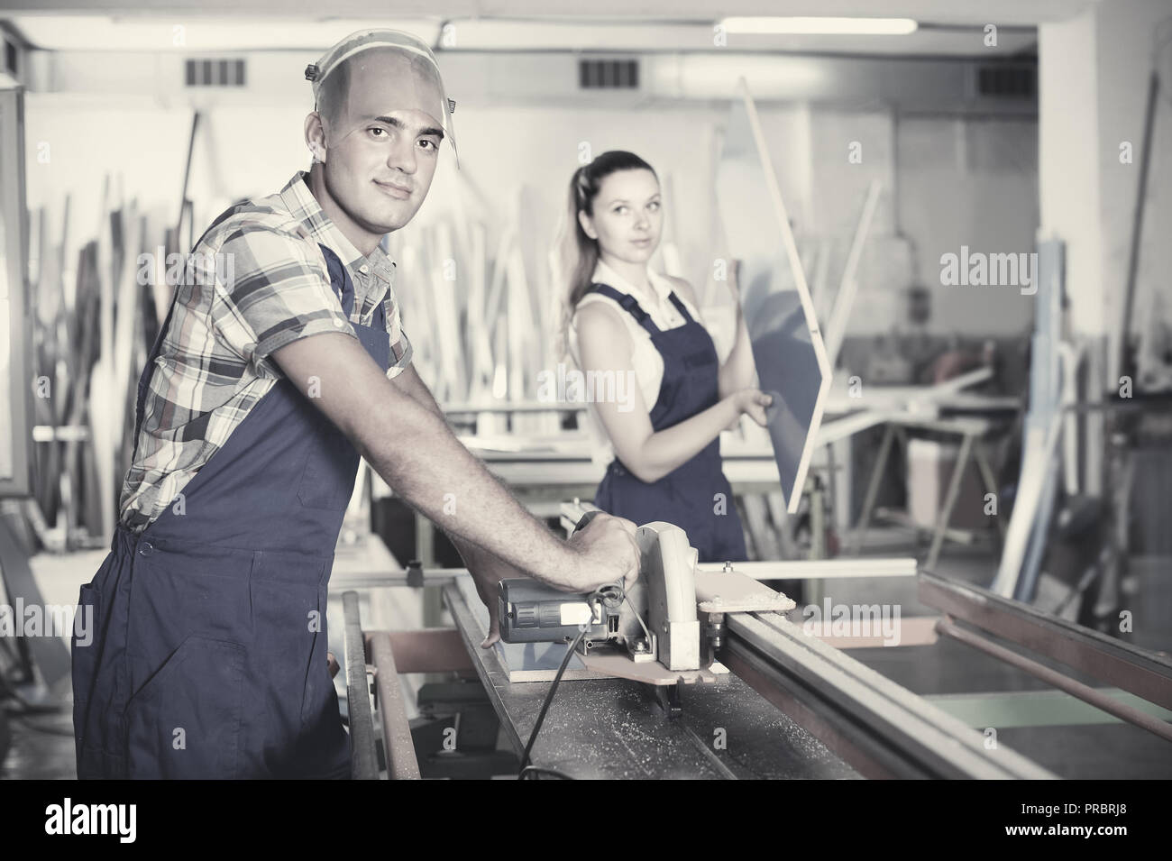 Professional workman is ready to work on circular saw in assembly shop ...