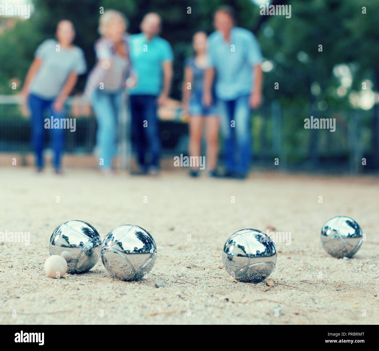 Males and females playing petanque in th park on holidays Stock Photo ...