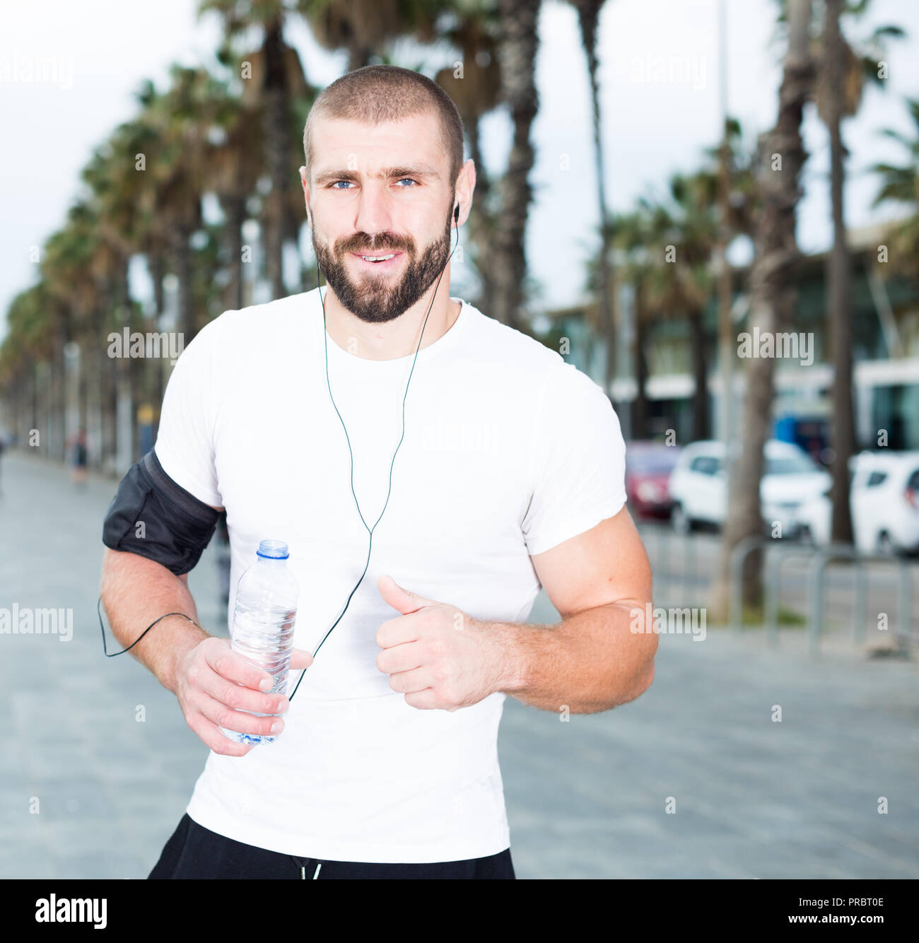 Athletic male stopped to rest while running Stock Photo - Alamy