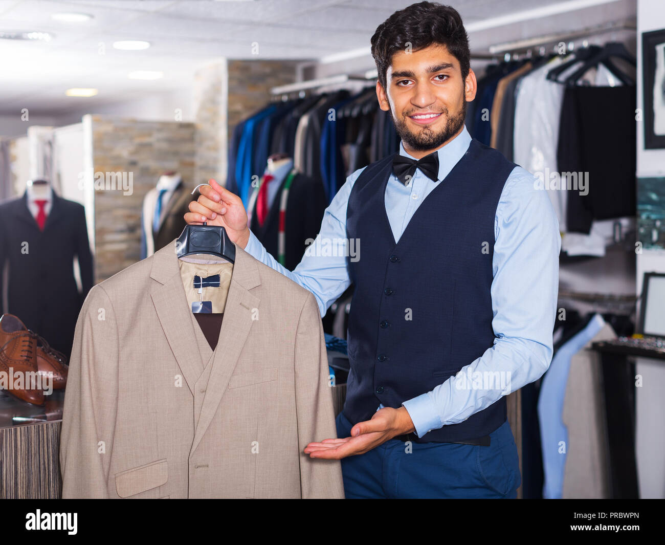 Male customer demonstrating his choice of suit in clothes store Stock ...