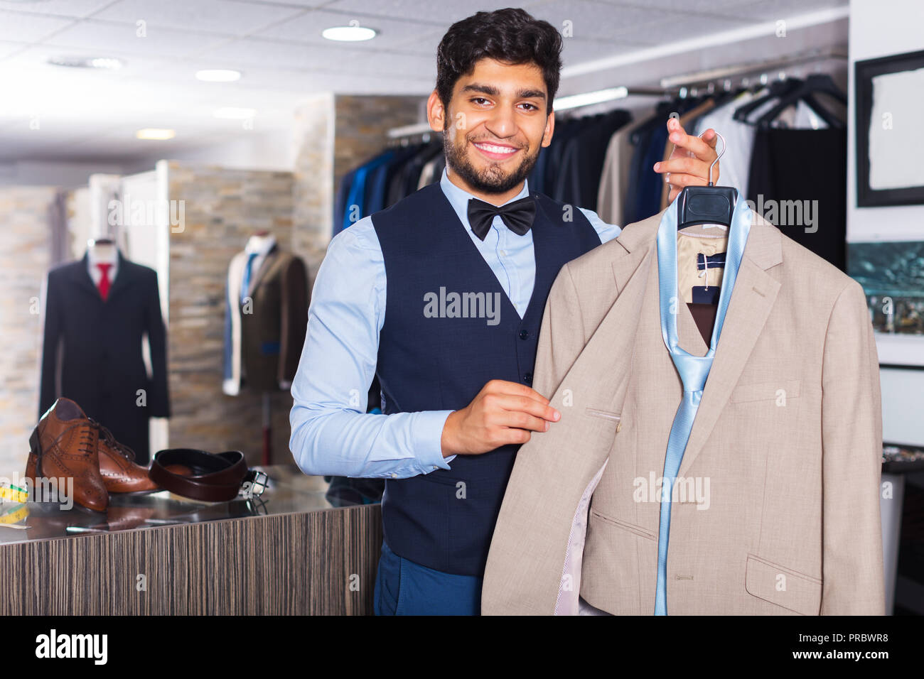 Male client demonstrating his choice of suit in store Stock Photo - Alamy