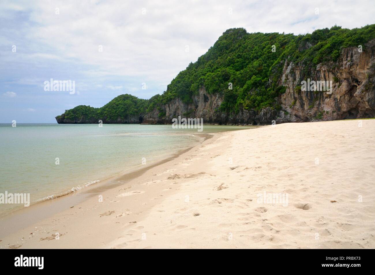 Paradise Thung San beach with white sand and rocky limestone cliff at ...