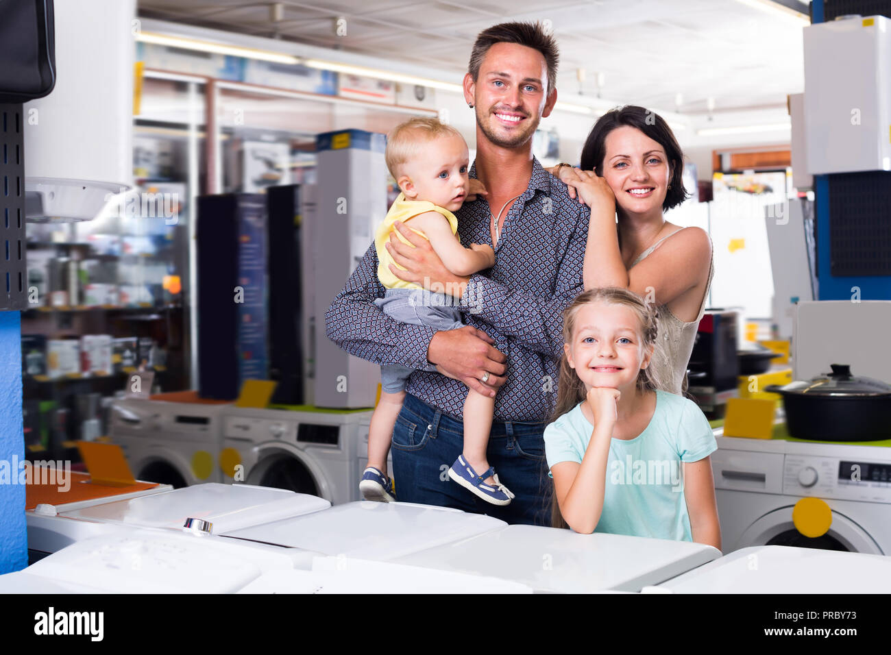 Family with two children shopping together in shop of household ...