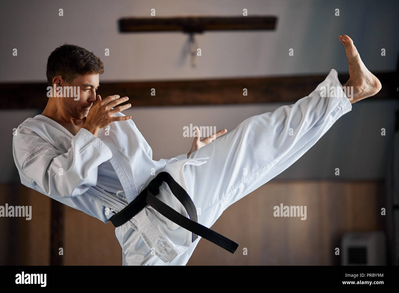 black belt karate fighter training hight kick Stock Photo - Alamy