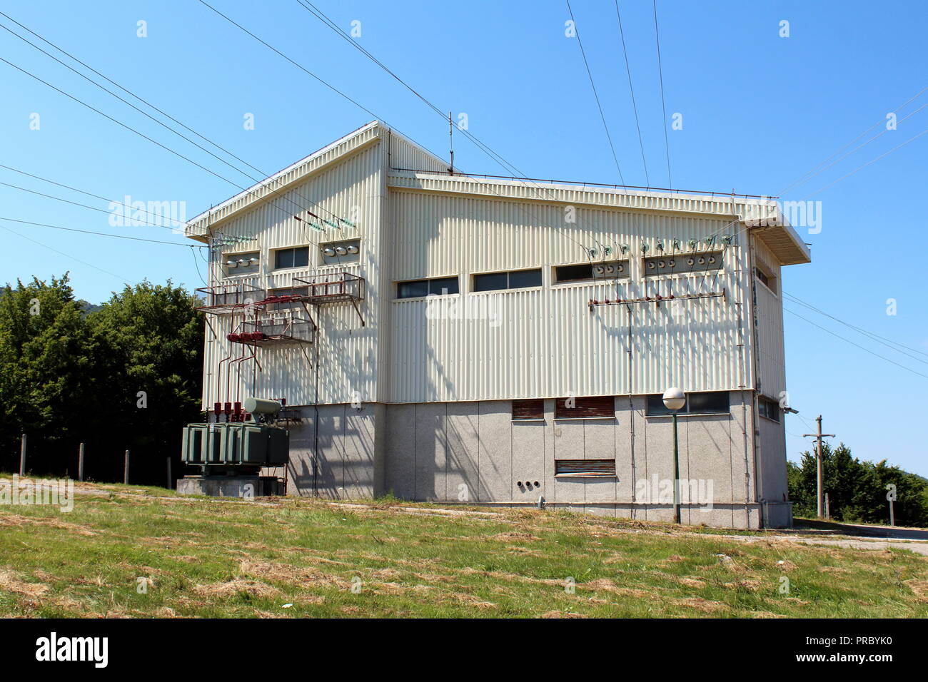 Large electrical company concrete white building coated with metal ...