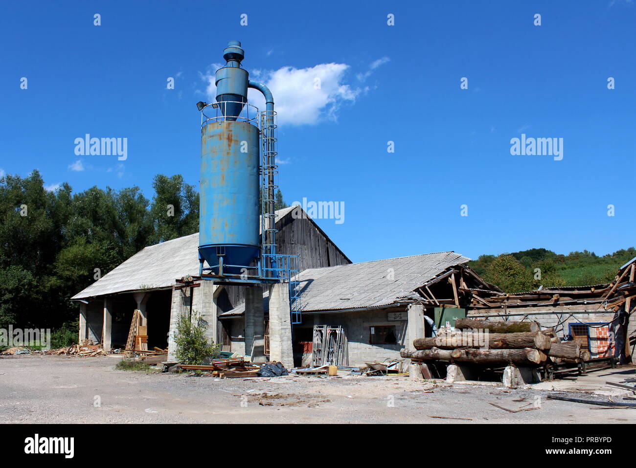 Old rarely used sawmill buildings with partially destroyed roof and ...