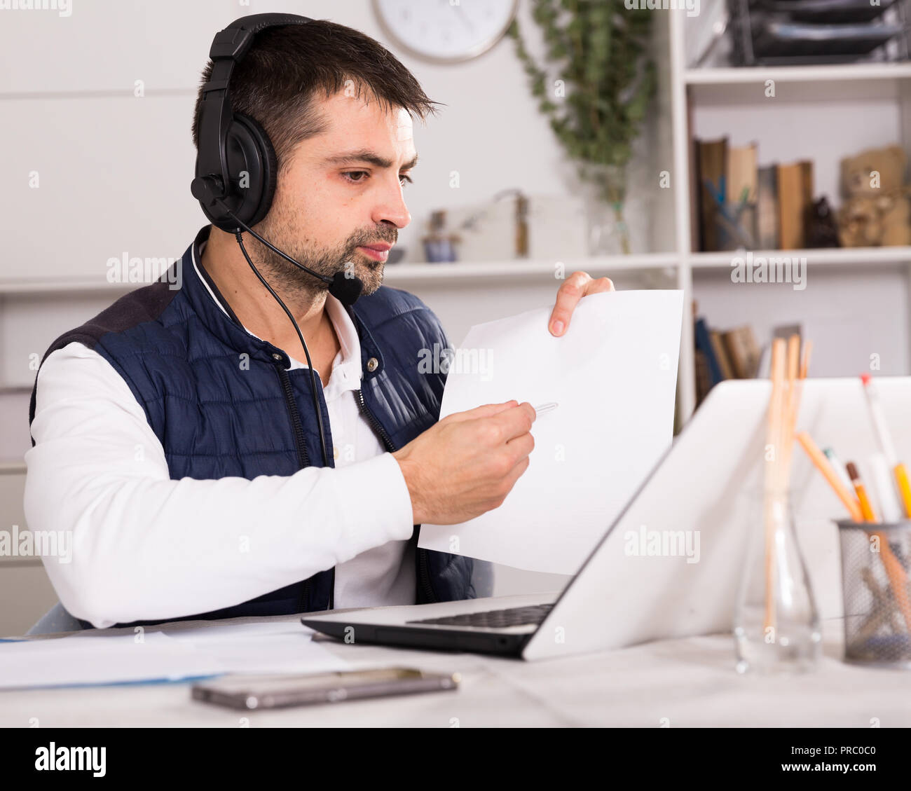 Call center man operator with headset talking with client in agency ...