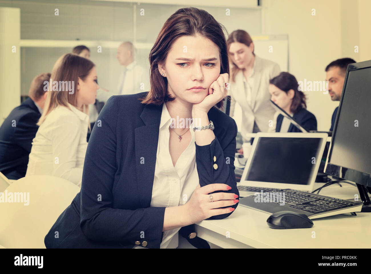 Portrait of pleasant serious girl in modern open plan office on ...