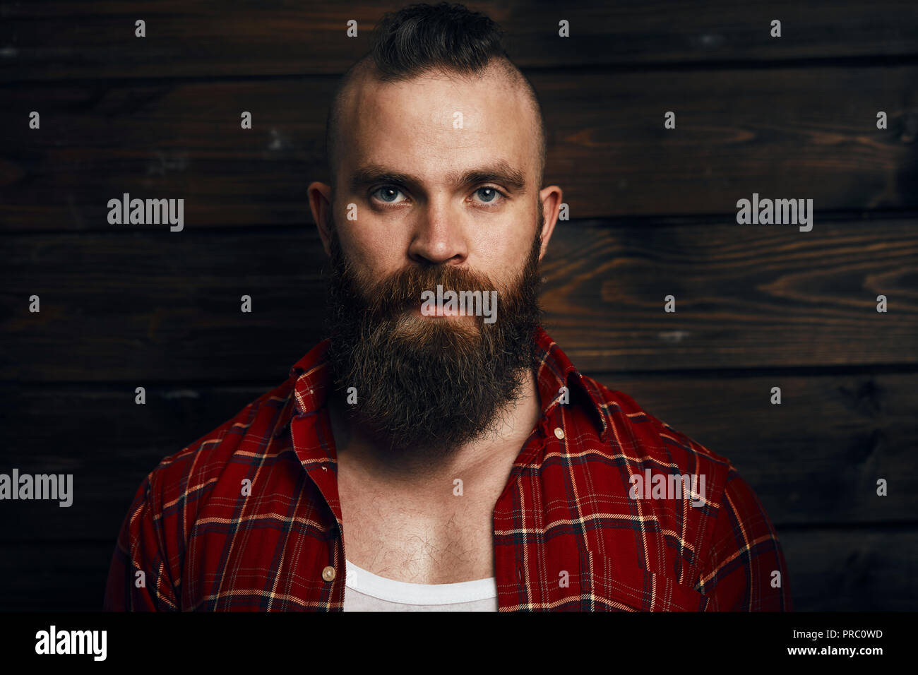 Headshot of Caucasian male with beard and mohawk, dressed in checkered ...