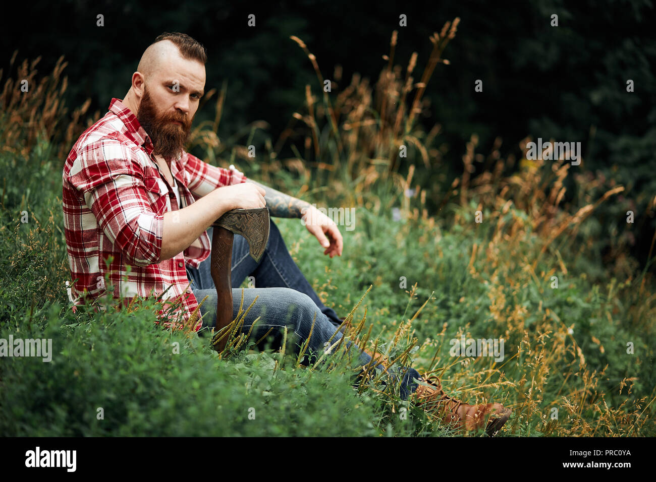 Lumberjack sitting in forest resting after hard work Stock Photo - Alamy