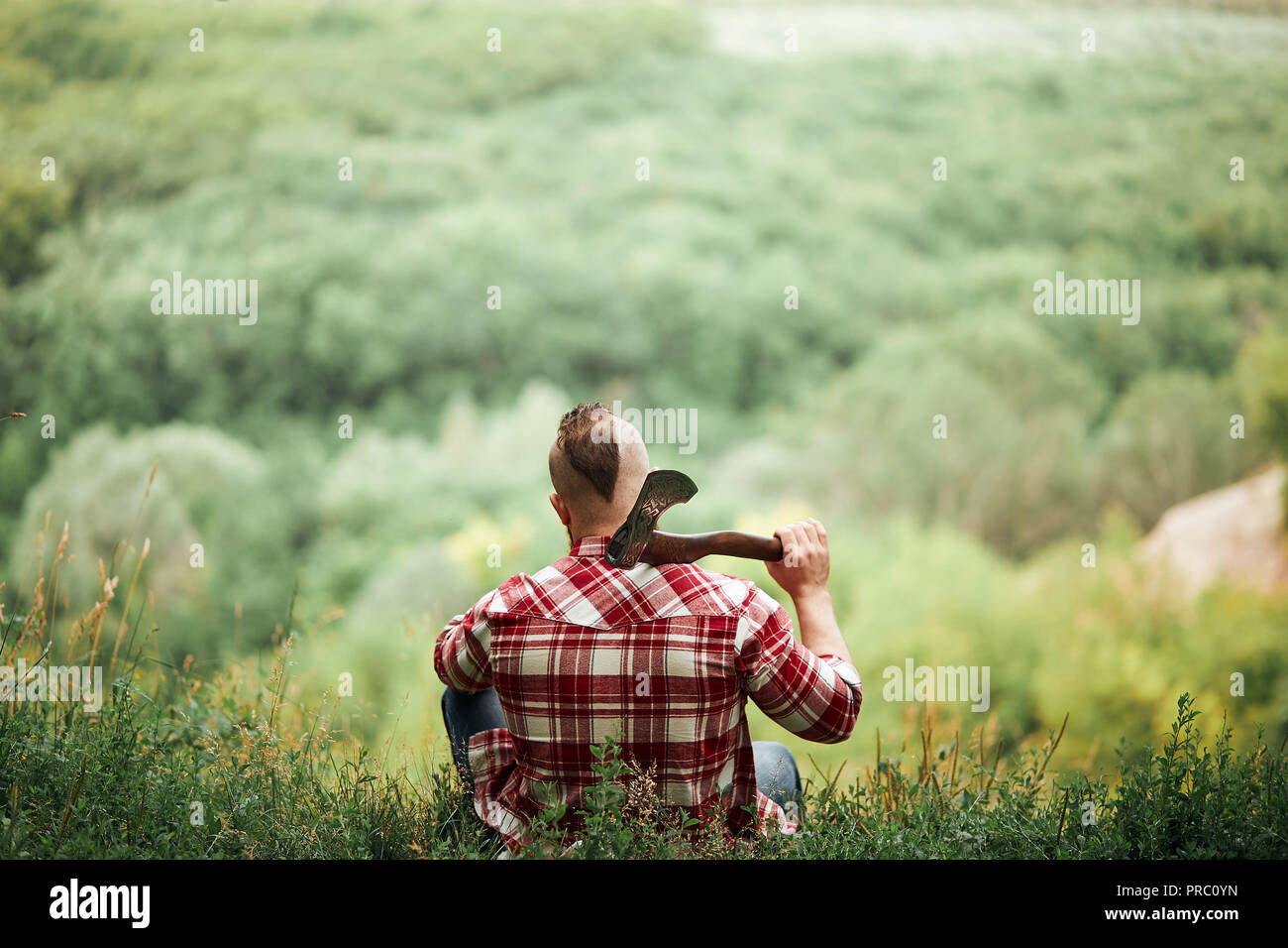 Lumberjack sitting in forest resting after hard work Stock Photo - Alamy