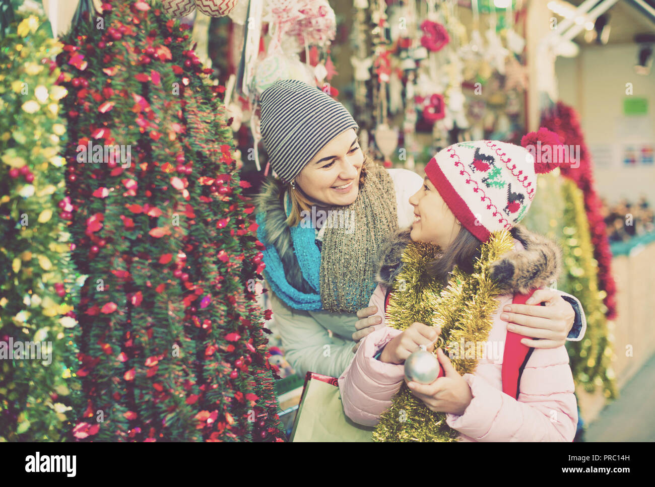 Glad female customers staring at counter of Christmas market. Focus on ...