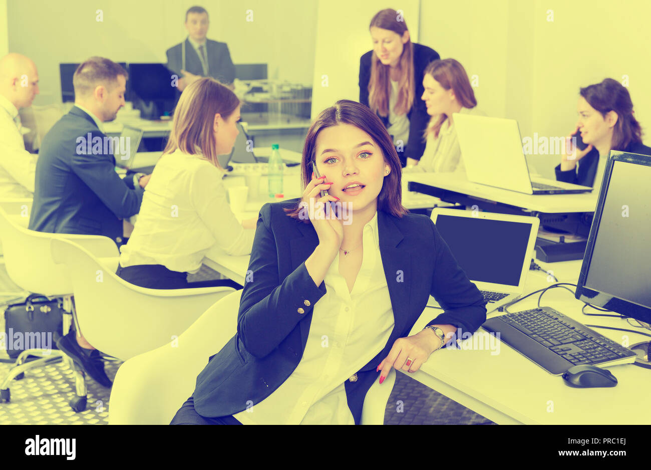 Young businesswoman having phone call conversation at workplace in ...