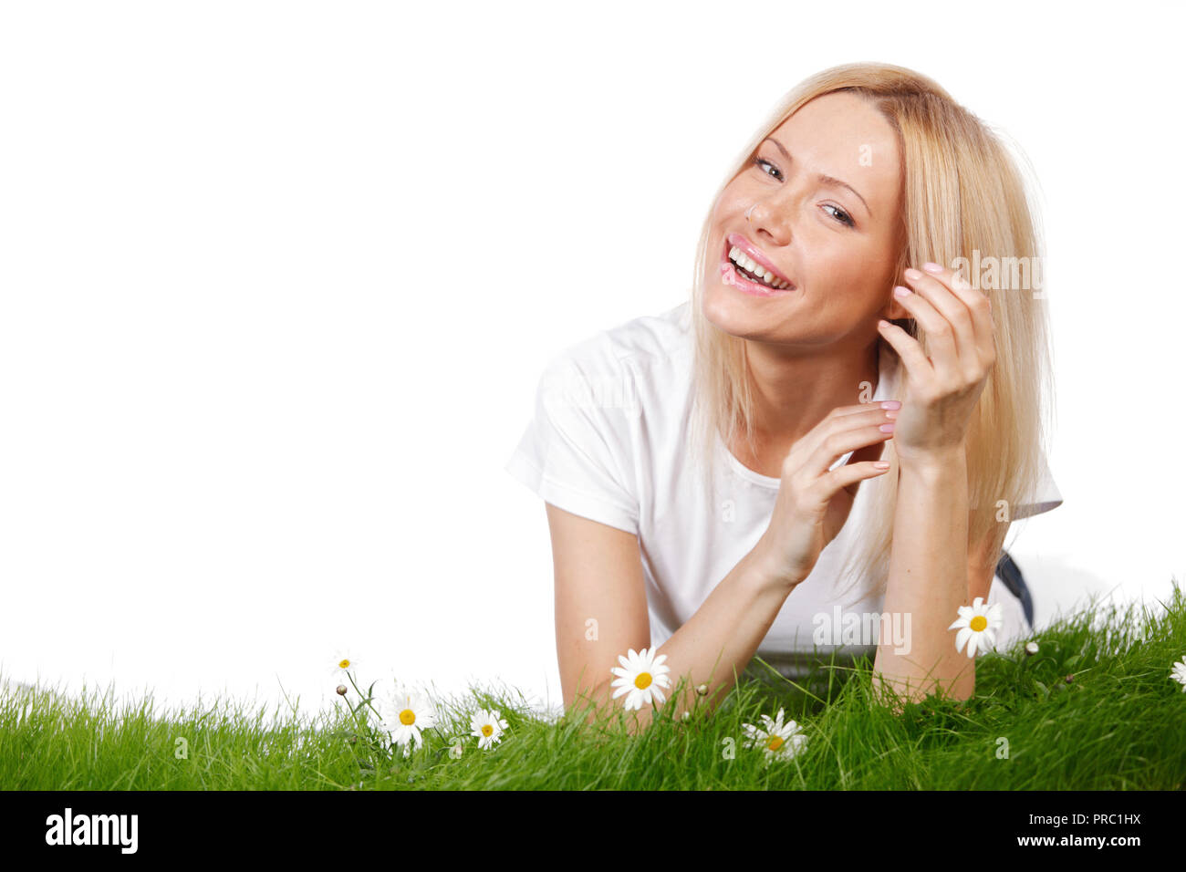Beautiful Young Blonde Woman Lying On Grass With Chamomile Flowers