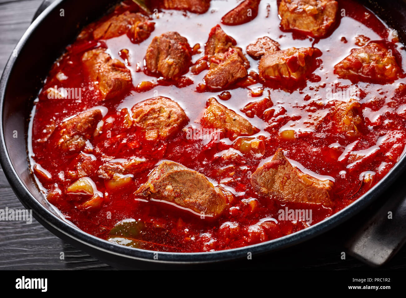 close-up of hearty Red Chile and Pork Stew or Carne Adobada in a dutch ...