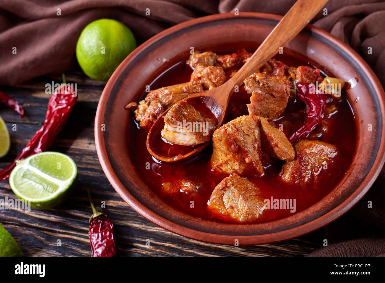 hearty Red Chile and Pork Stew or Carne Adobada in a clay bowl with ...