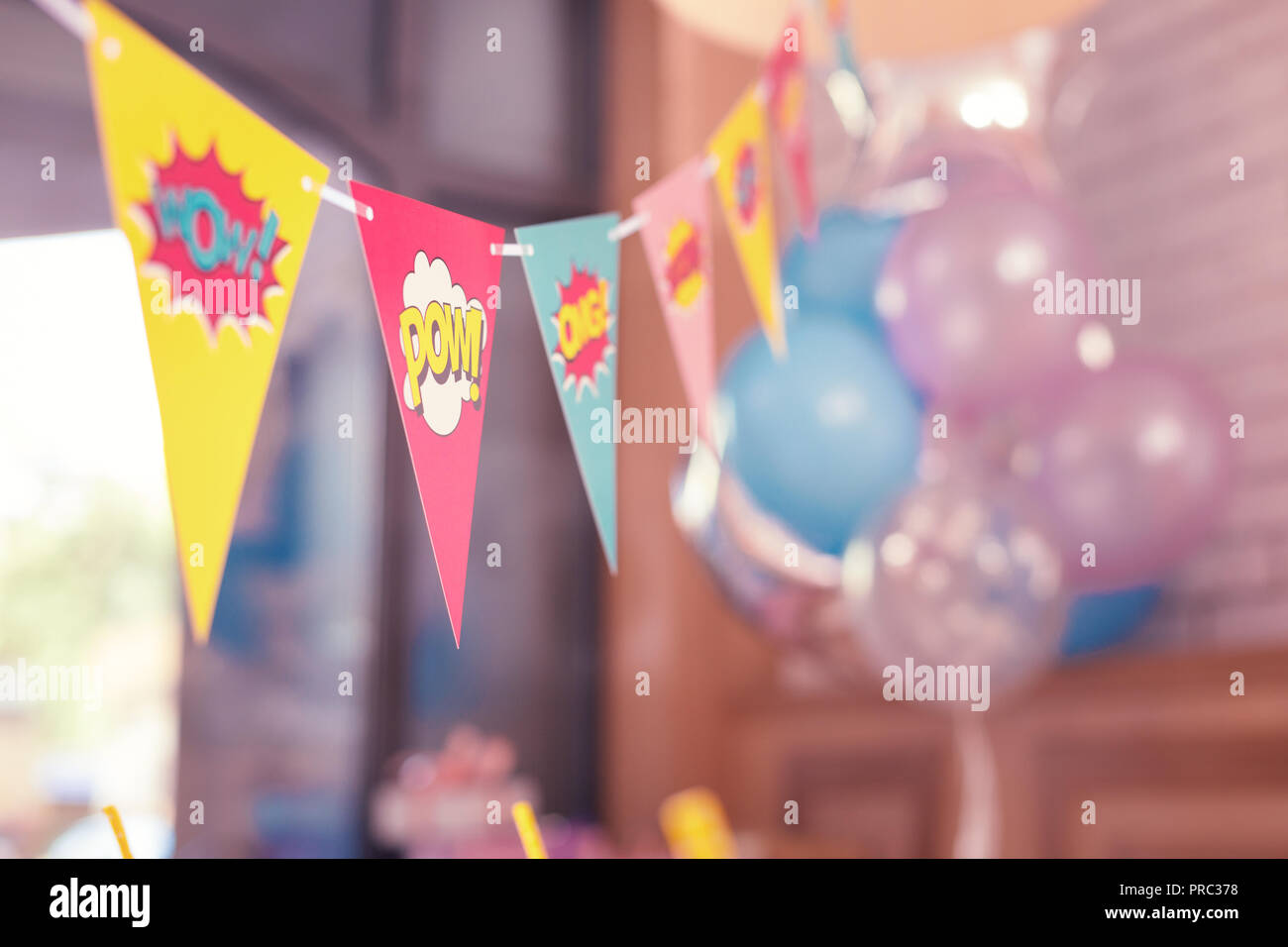 Colorful triangle party flags placed in the room before birthday party ...