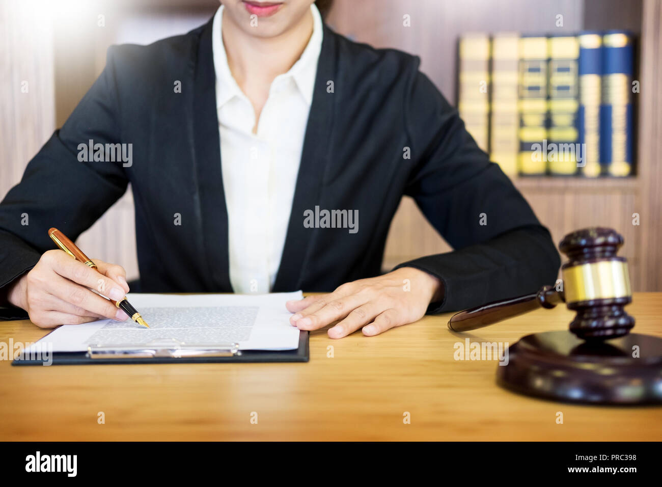 lawyer judge reading documents at desk in courtroom working on wooden ...