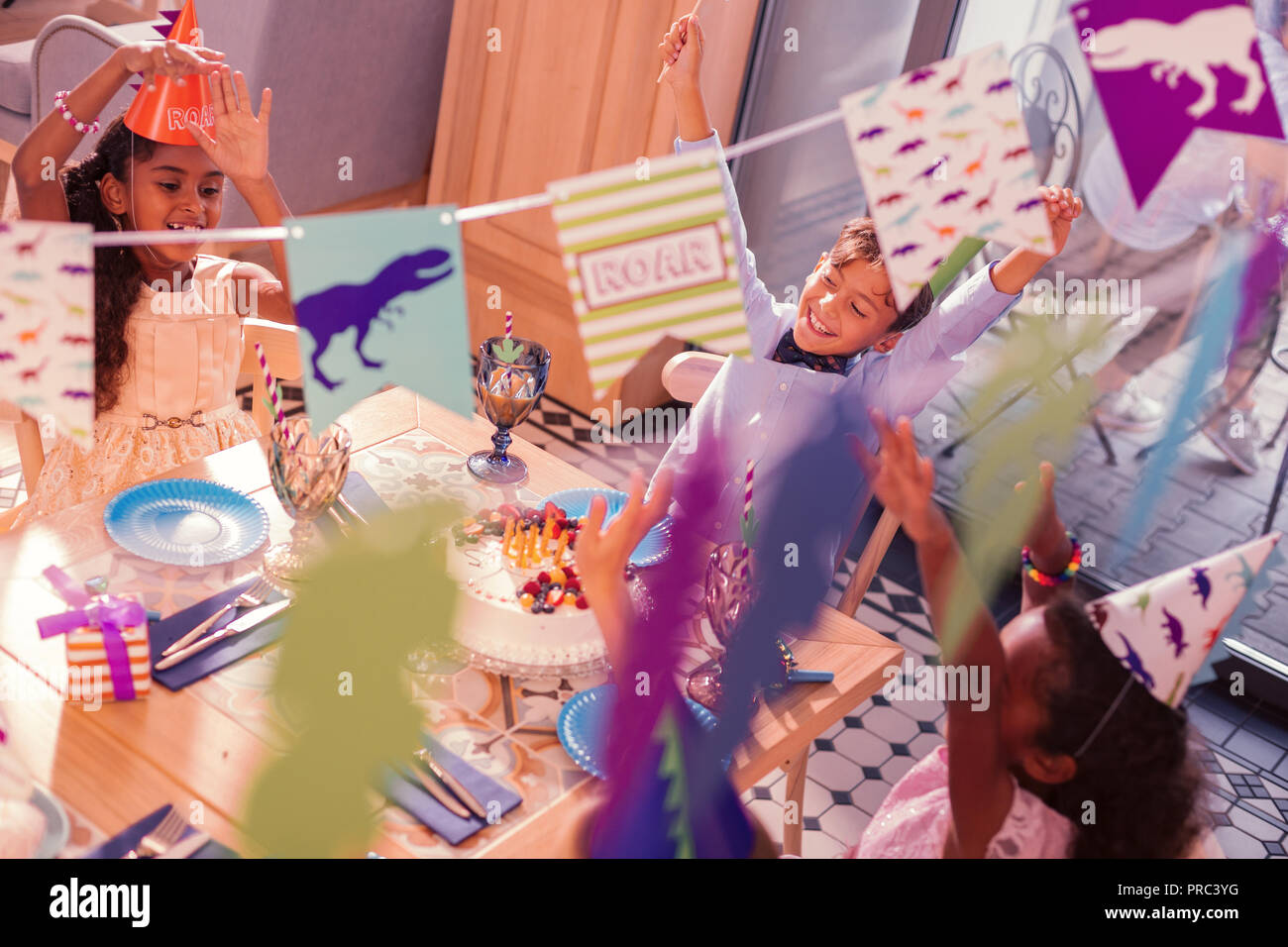 Children putting hands up hi-res stock photography and images - Alamy