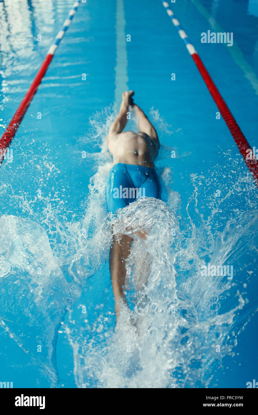 Photo on top of man swimming on back in swimming pool Stock Photo - Alamy