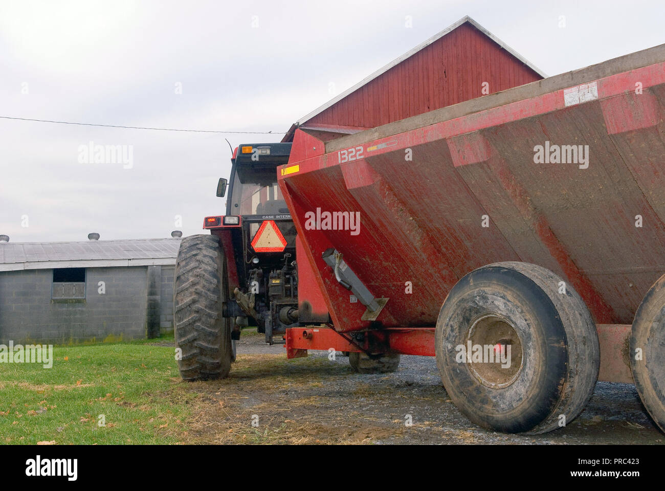 2006 - Farmer in tractor pulls mid-sized manure spreader to help ...