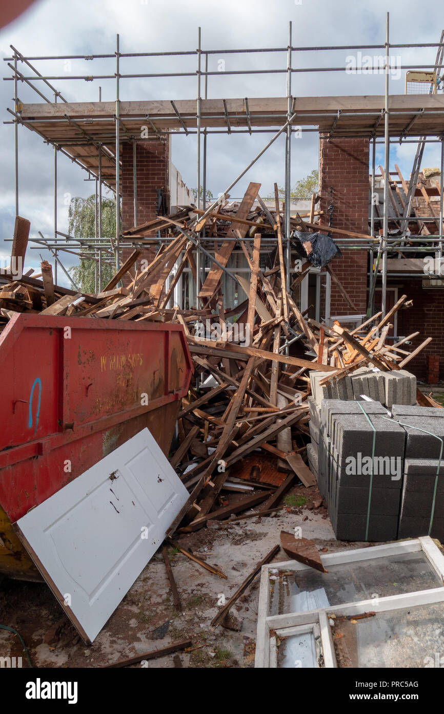 pile of scrap wood being taken out of a 1960's house being completely ...