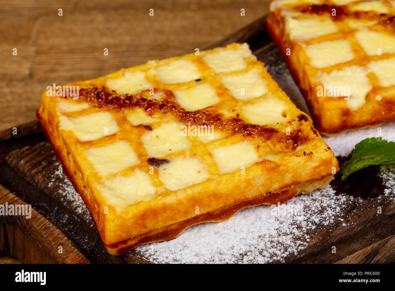 Sweet Belgian Waffer over wooden background Stock Photo - Alamy
