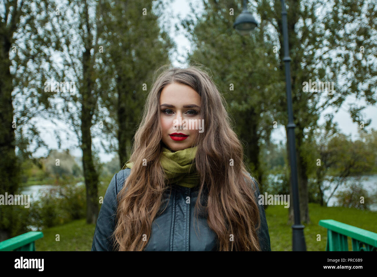 Pretty woman in park outdoor on green nature background Stock Photo - Alamy