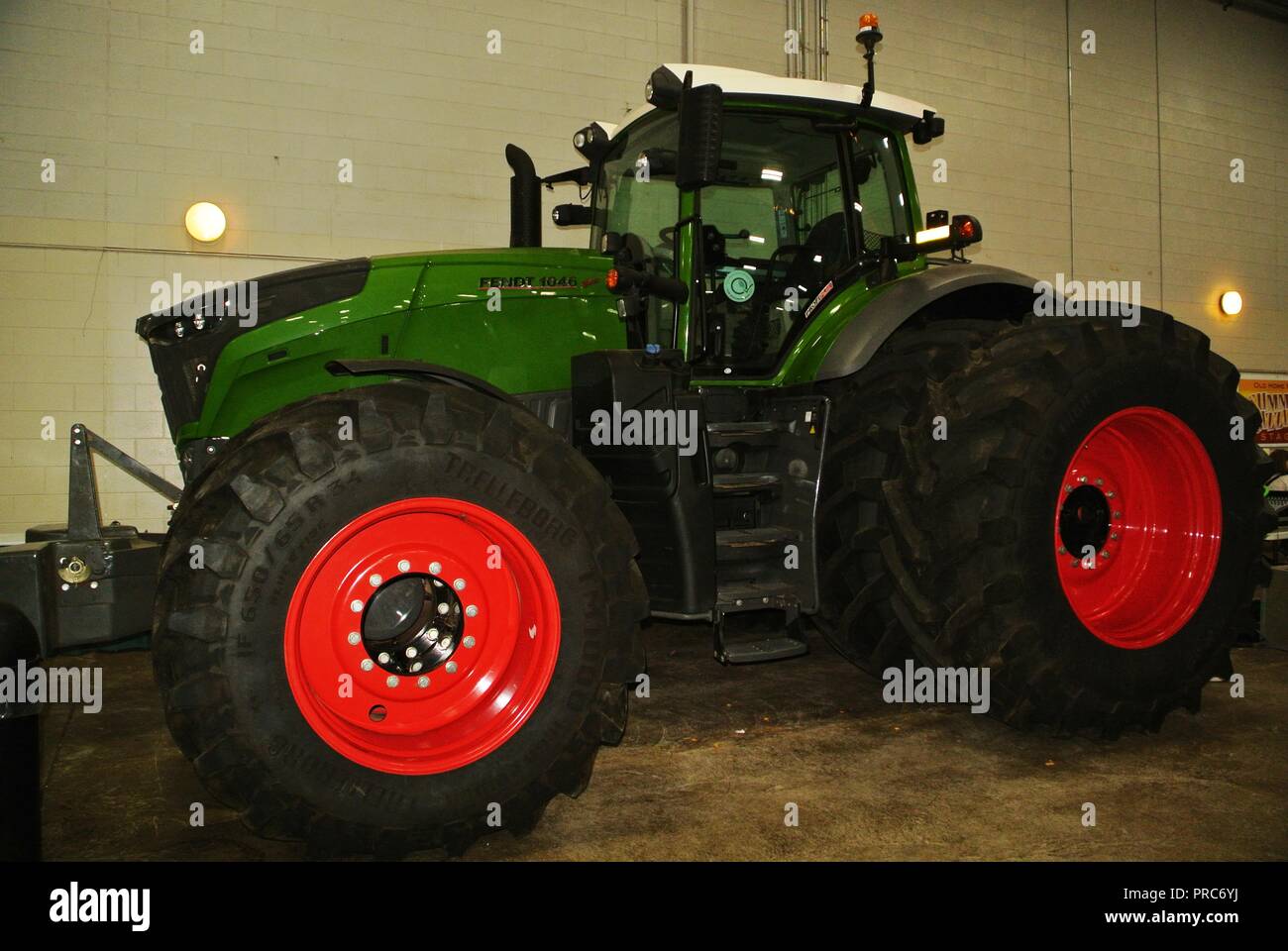 Composite image of a modern green agricultural generic tractor with red ...