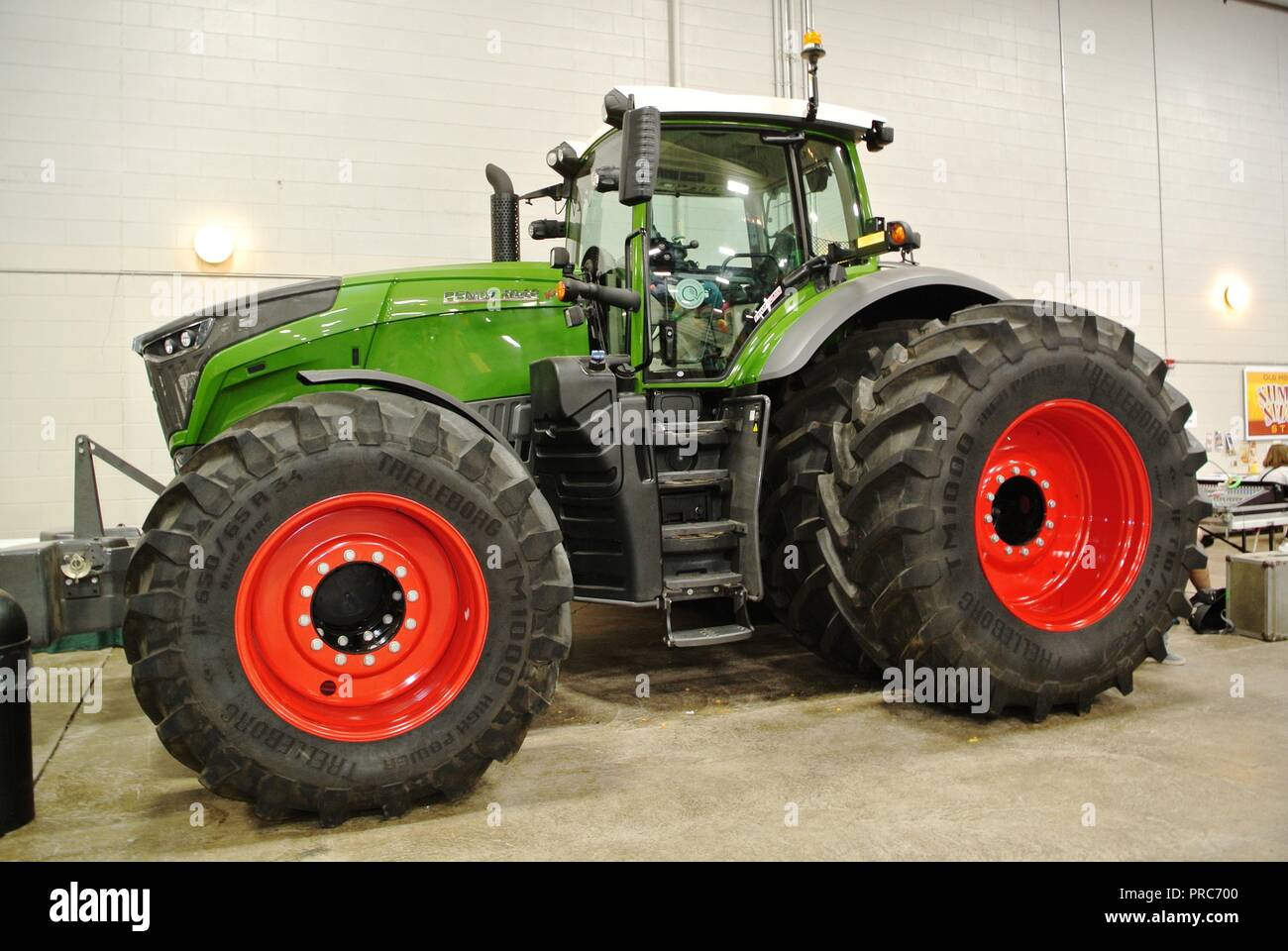 Composite image of a modern green agricultural generic tractor with red ...