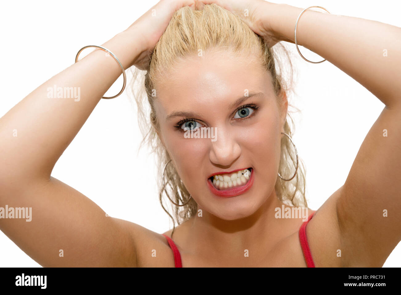 Frustrated pretty blonde woman with hands on her head isolated on the ...