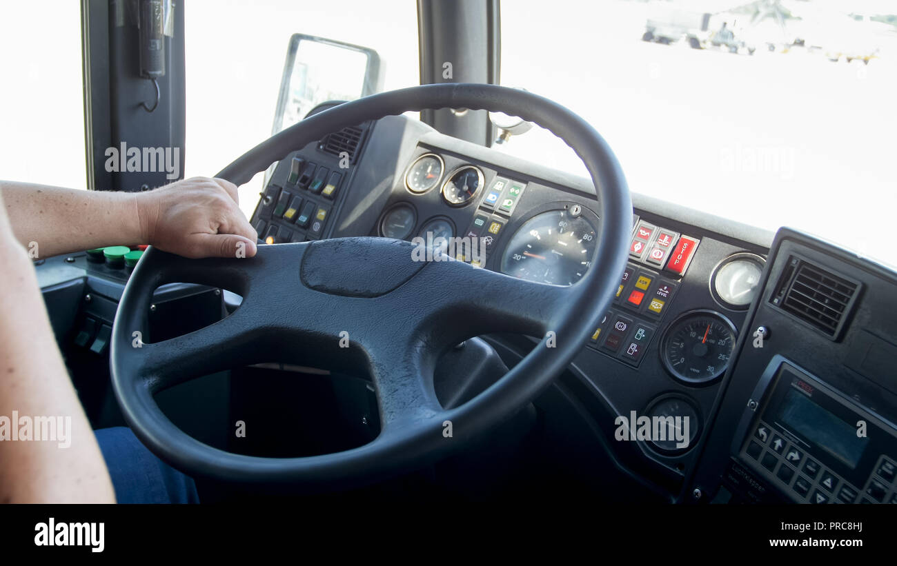Closeup image of male driver driving public bus Stock Photo - Alamy
