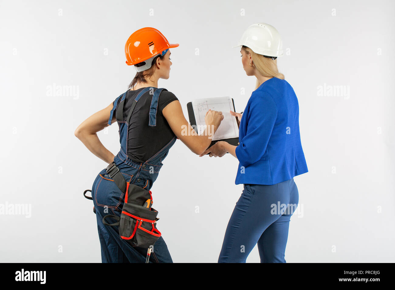 Two woman architecture look in plan and discussing the problems of ...