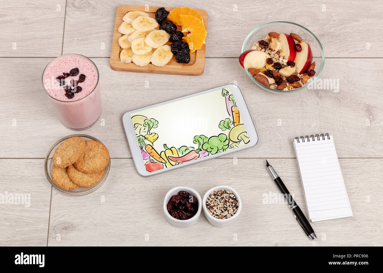 Healthy food composition with tablet Stock Photo - Alamy