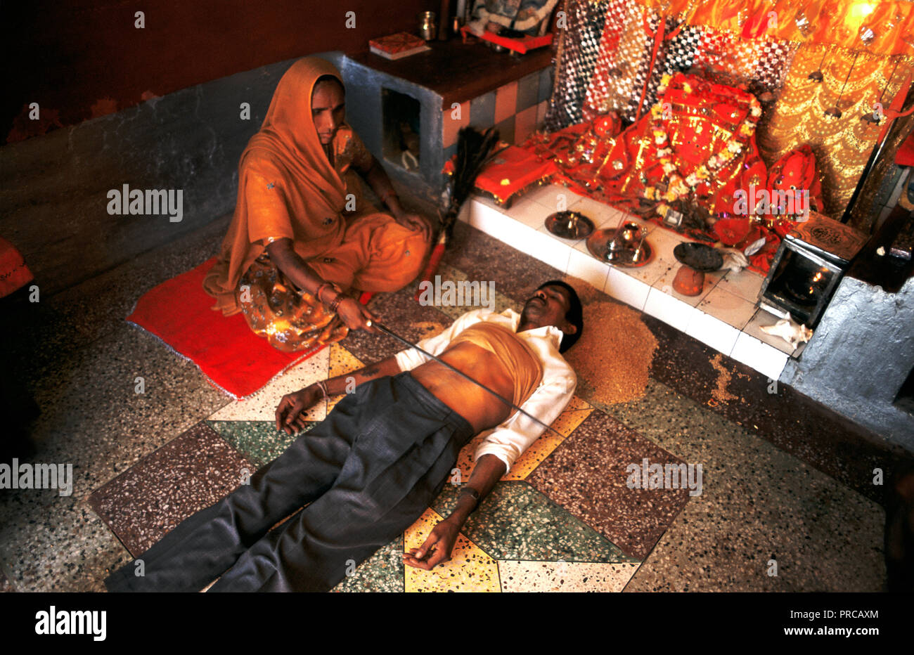 Traditional healer treating a patient by invoking the hindu goddess ...