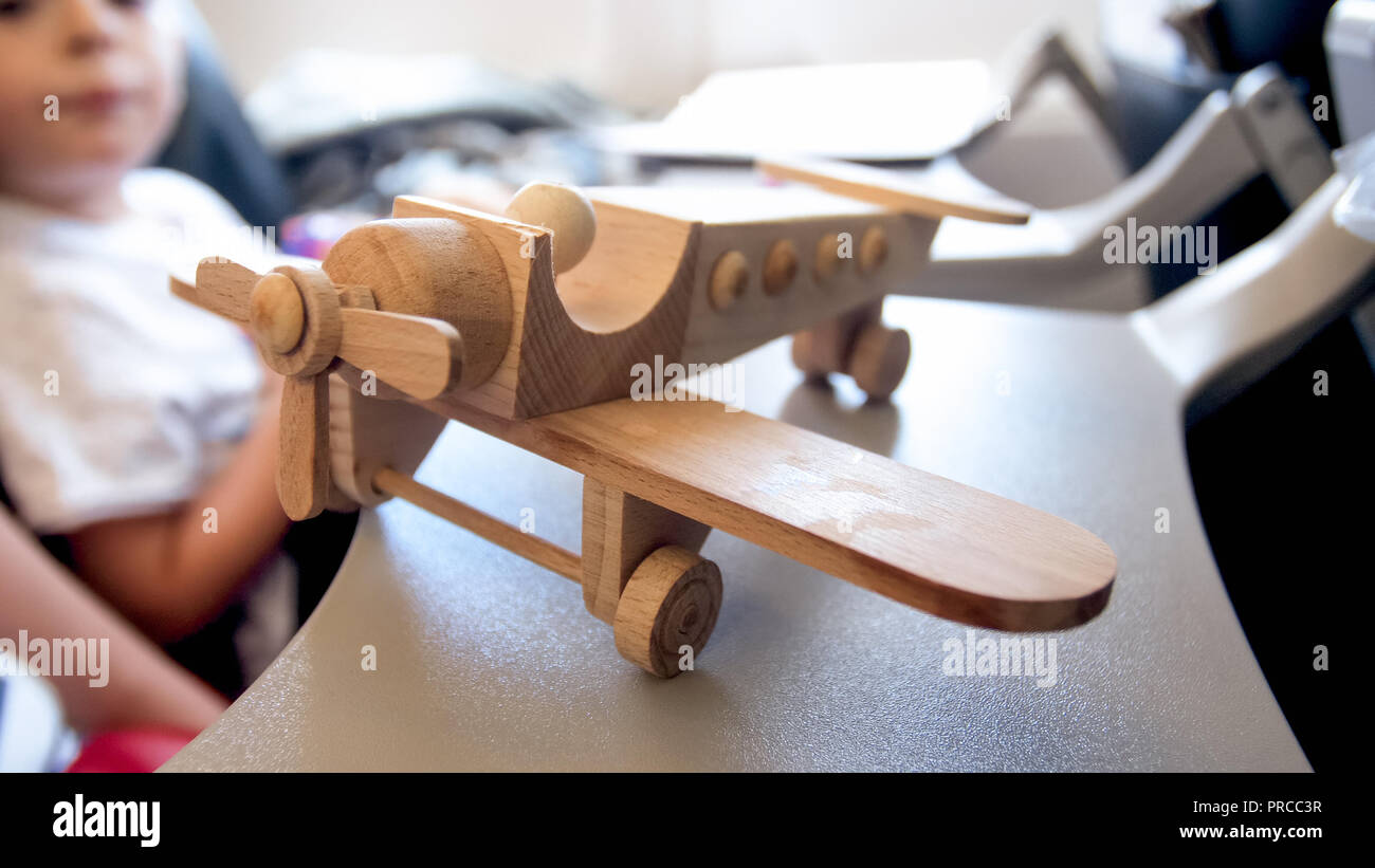 Closeup photo of wooden toy miniature of pilot in plane in rela jet ...
