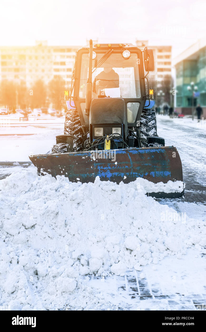 Blue bulldozer cleans the streets after a heavy natural snowfall Stock ...