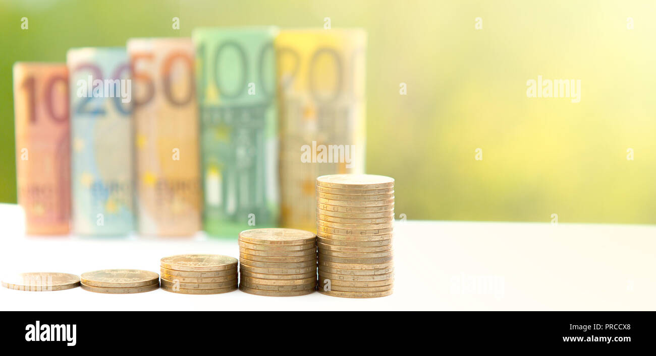 Histogram of coins and bamknotes on a green background. Concept of ...