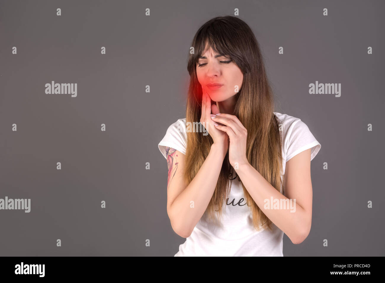 Medical concept about toothache. The girl is holding her hands on her ...