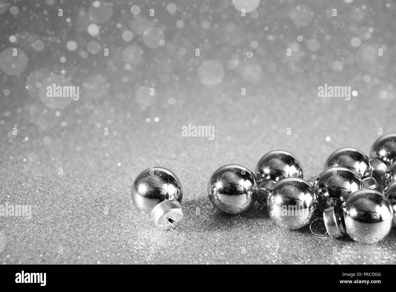 Christmas silver balls on shining glitter background Stock Photo - Alamy