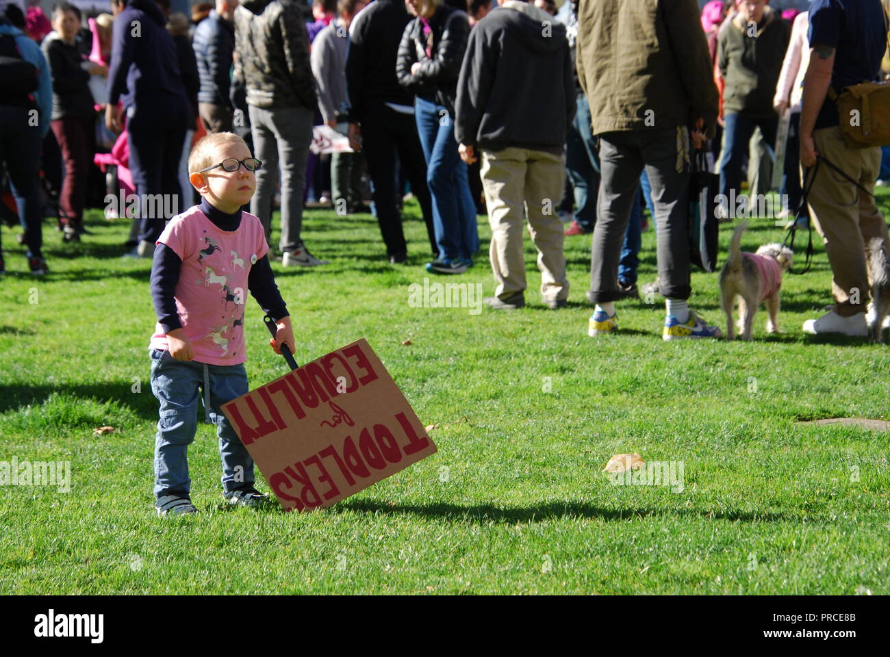 A young boy stands with a sign that says "toddlers for equality" during ...