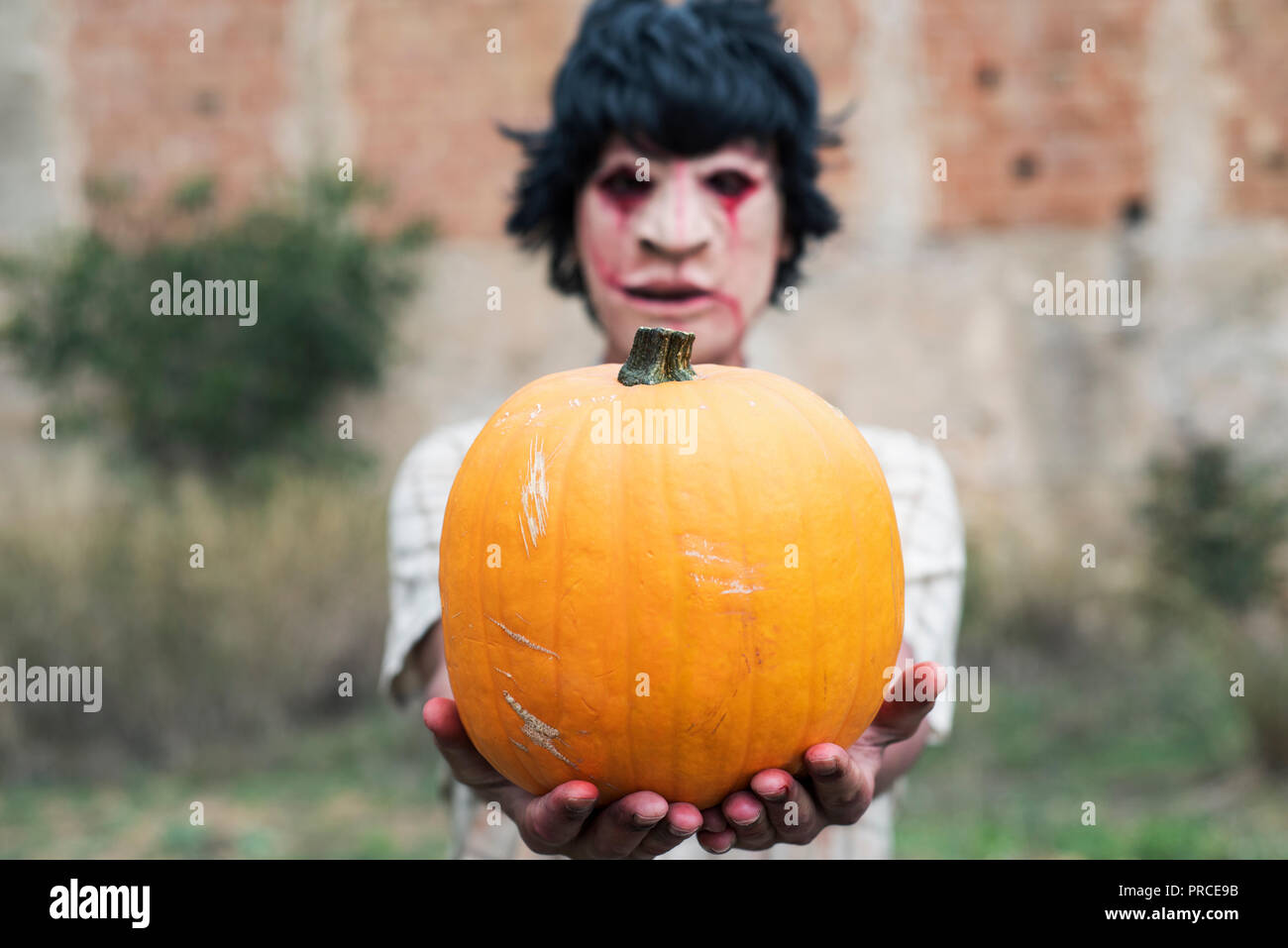 closeup of a scary disfigured man, wearing ragged and dirty clothes ...