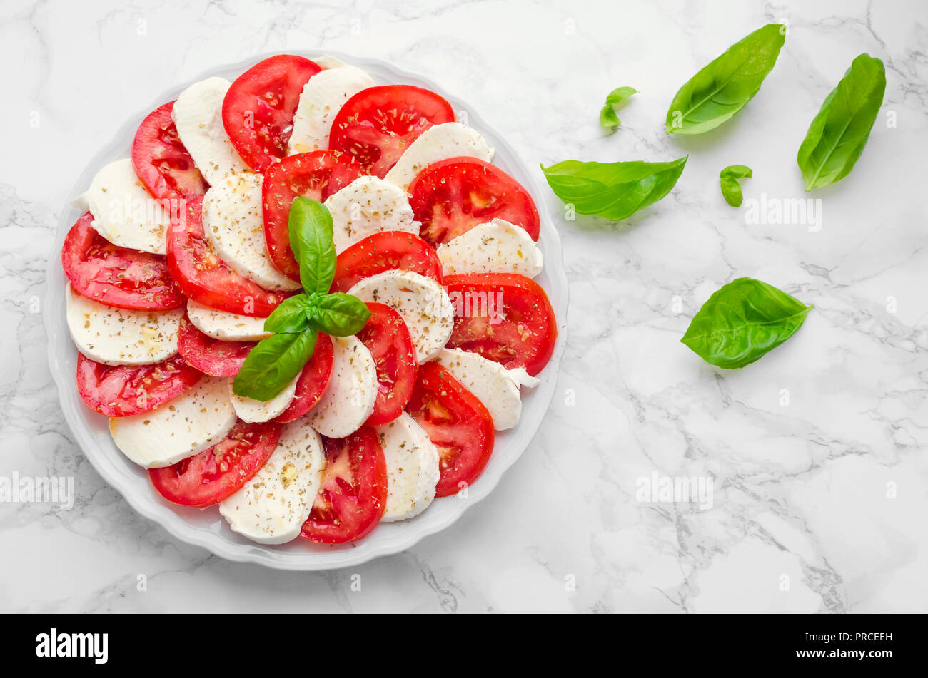 Plate of healthy classic delicious caprese salad with ripe tomatoes and ...