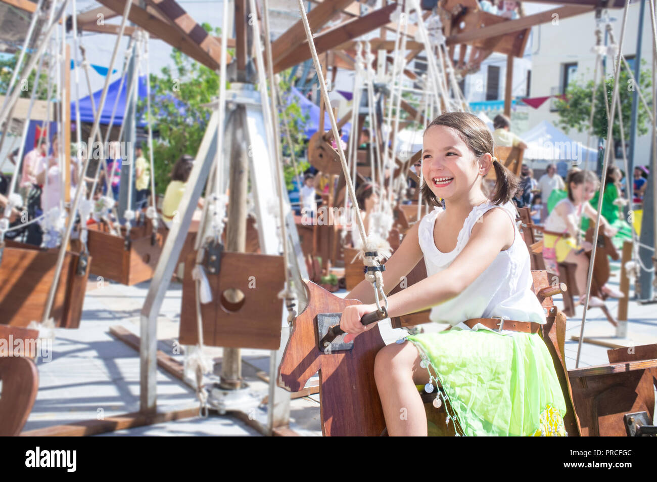 Child girl having fun at Human powered carousel. Motion blurred shot ...