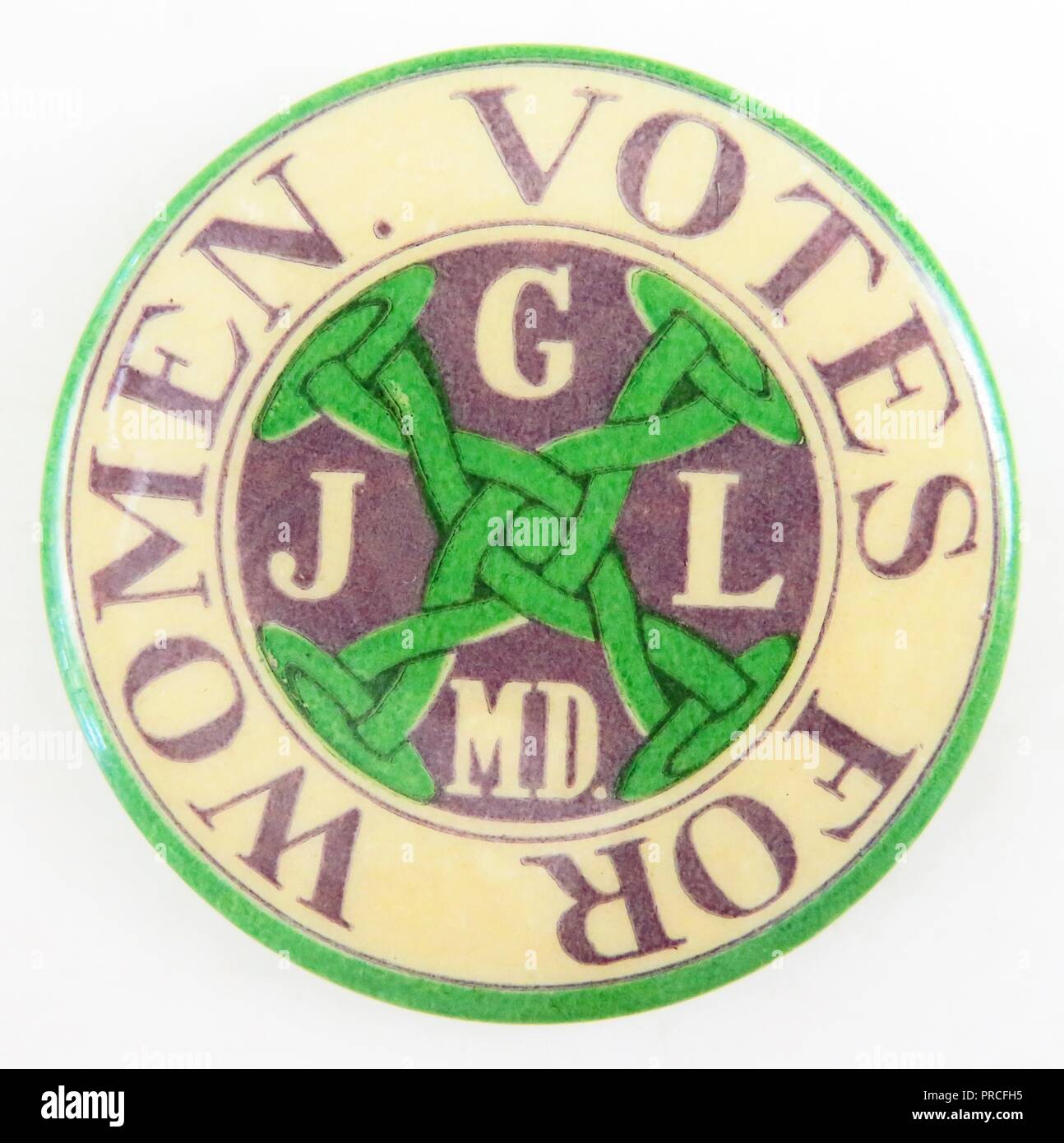 Purple, green, and white (or cream) suffrage pin, with the text 'Votes ...
