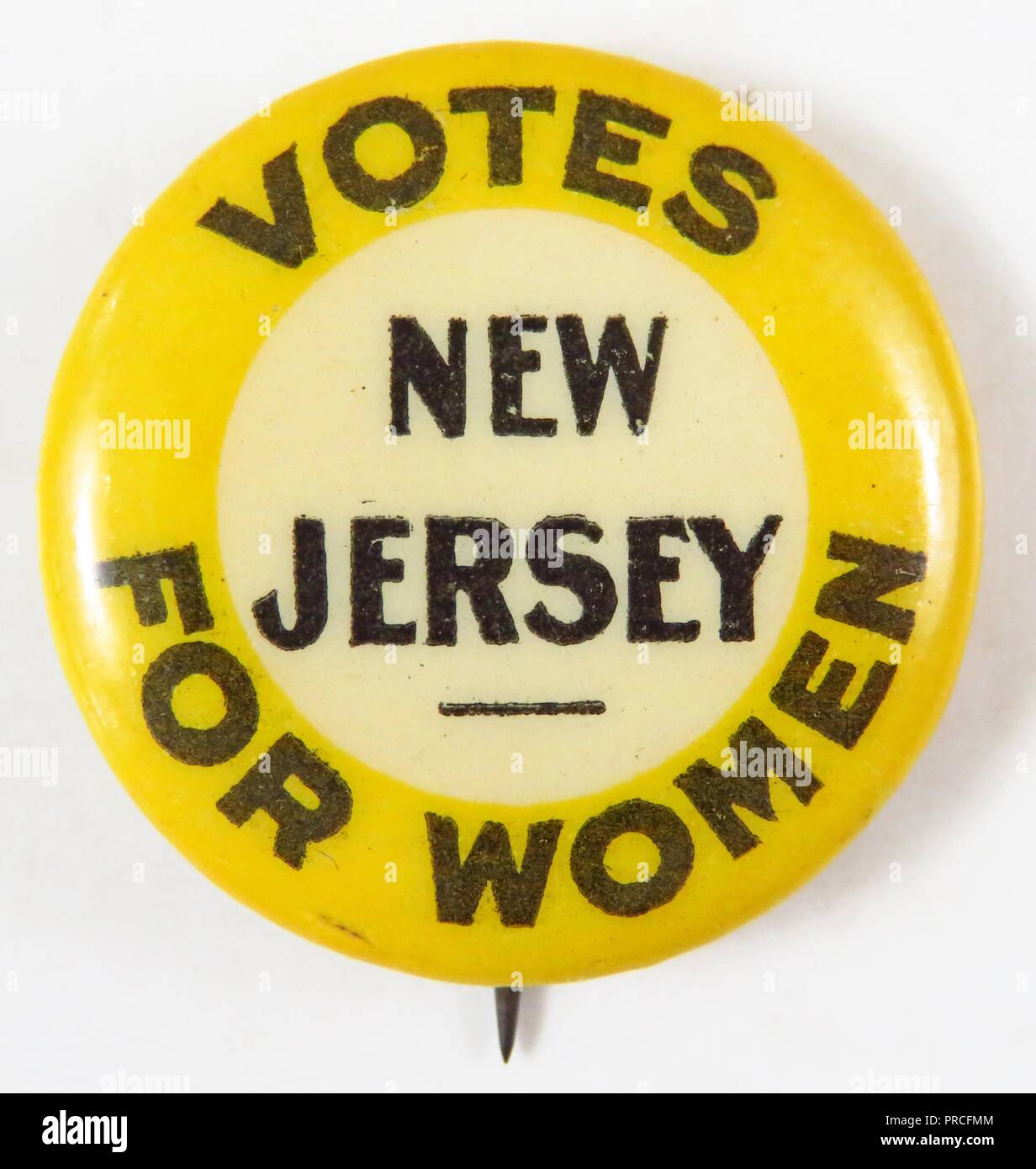 Yellow, black, and white suffrage pin, with the text 'Votes for Women ...